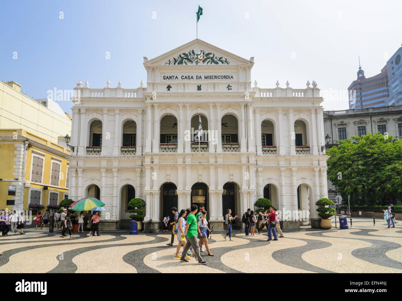 Mosaic cobbles of Senado Square and the white Holy House of Mercy ...