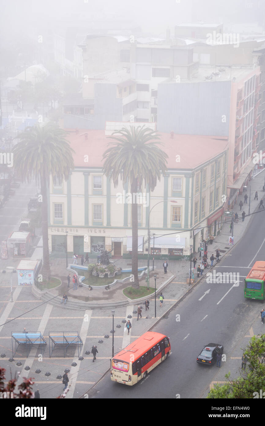 Aerial view of city street with bus traffic and people on sidewalks ...