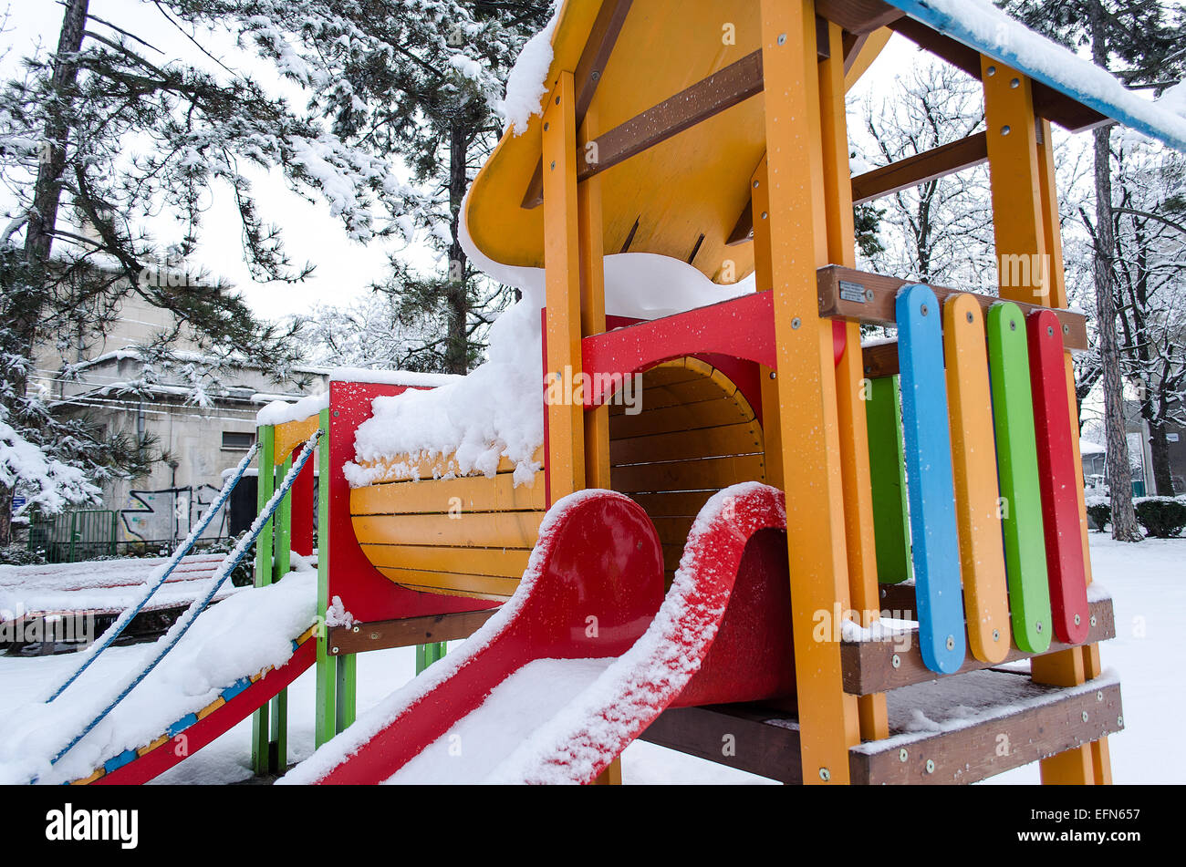 Children playground empty in the snow Stock Photo - Alamy