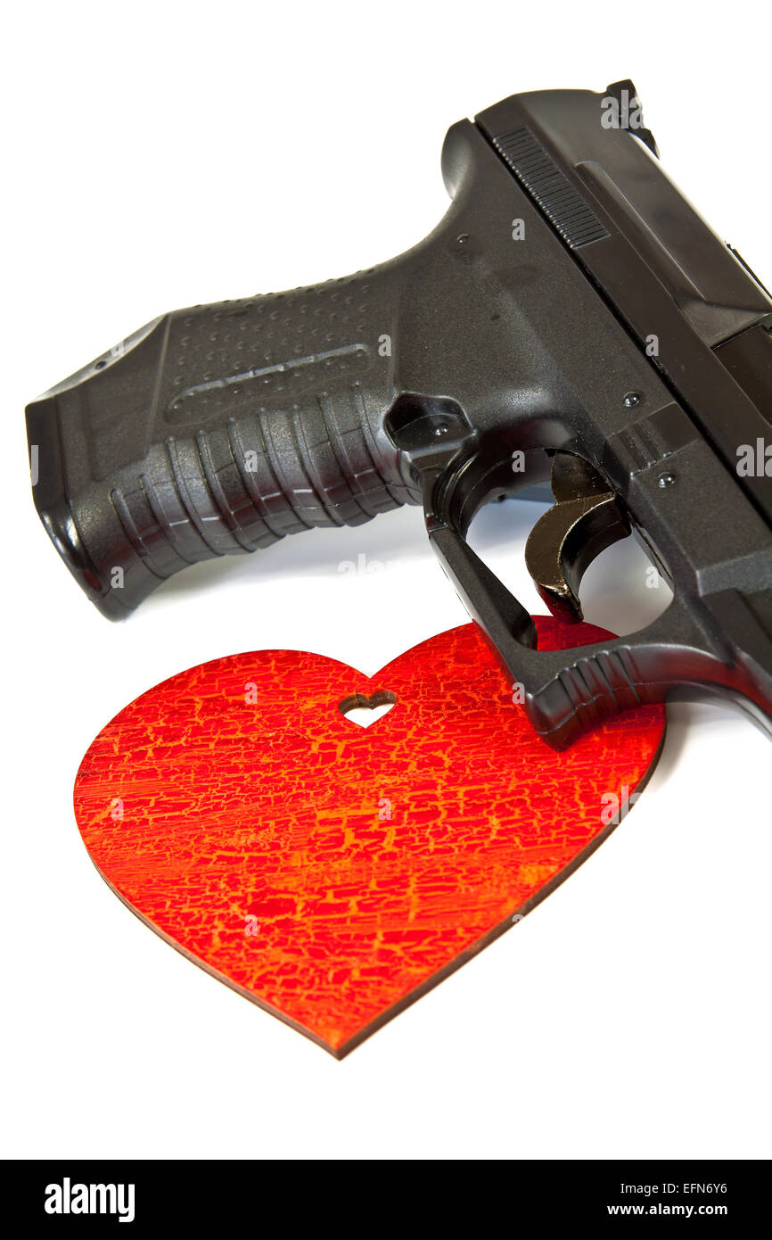 Pneumatic air gun and painted red wooden heart Stock Photo - Alamy