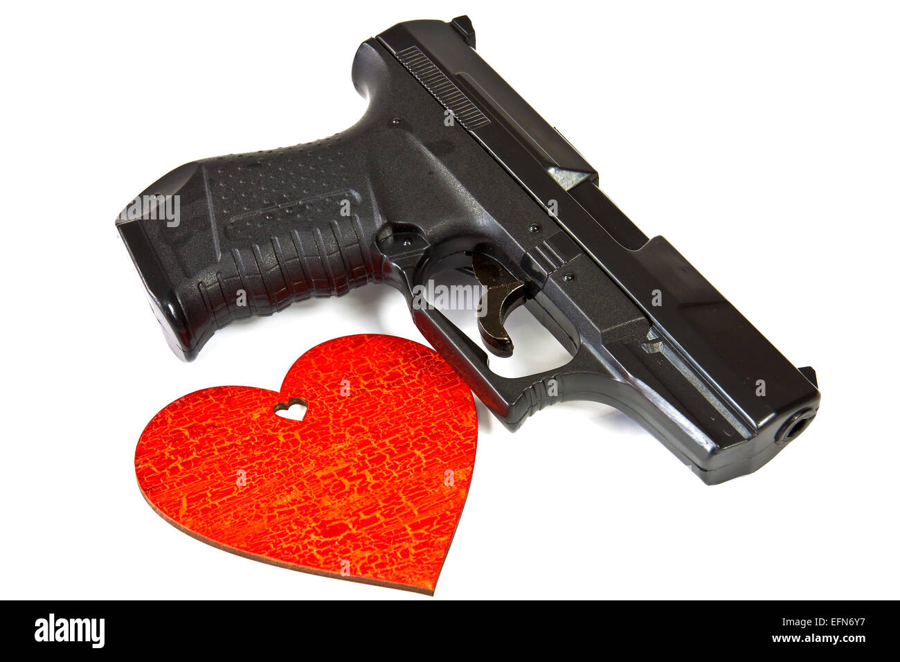 Pneumatic air gun and painted red wooden heart Stock Photo - Alamy