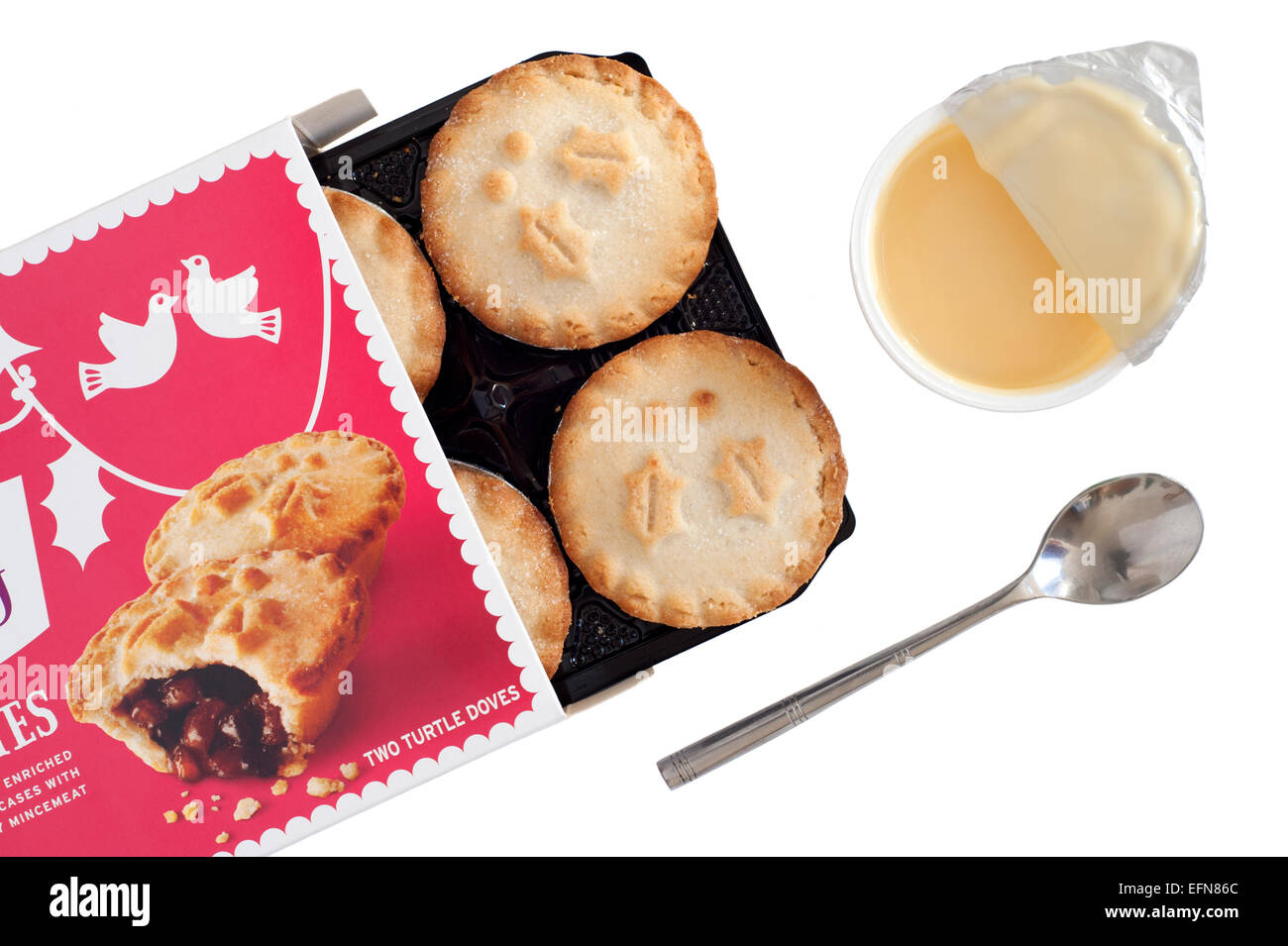 box of mince pies with pot of custard and spoon against a white ...