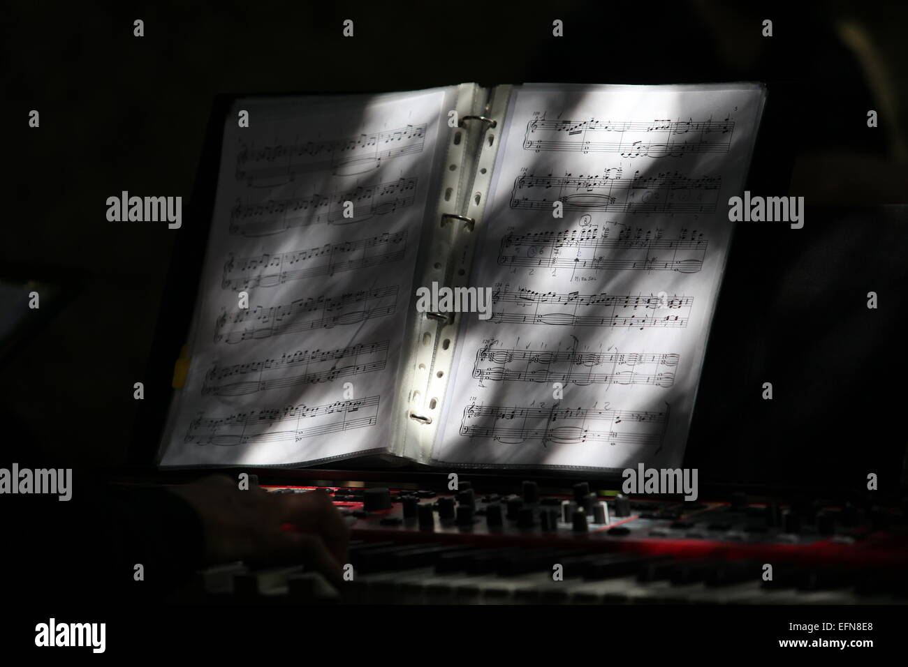 Sheet music in dappled light Stock Photo - Alamy