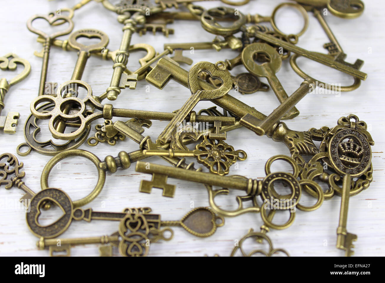 Pile of antique brass keys on a distressed white wood background Stock ...