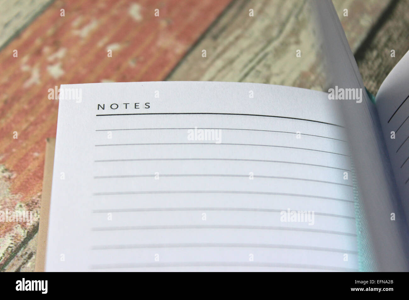 Open blank Notes page of diary, close up on rustic wooden background ...