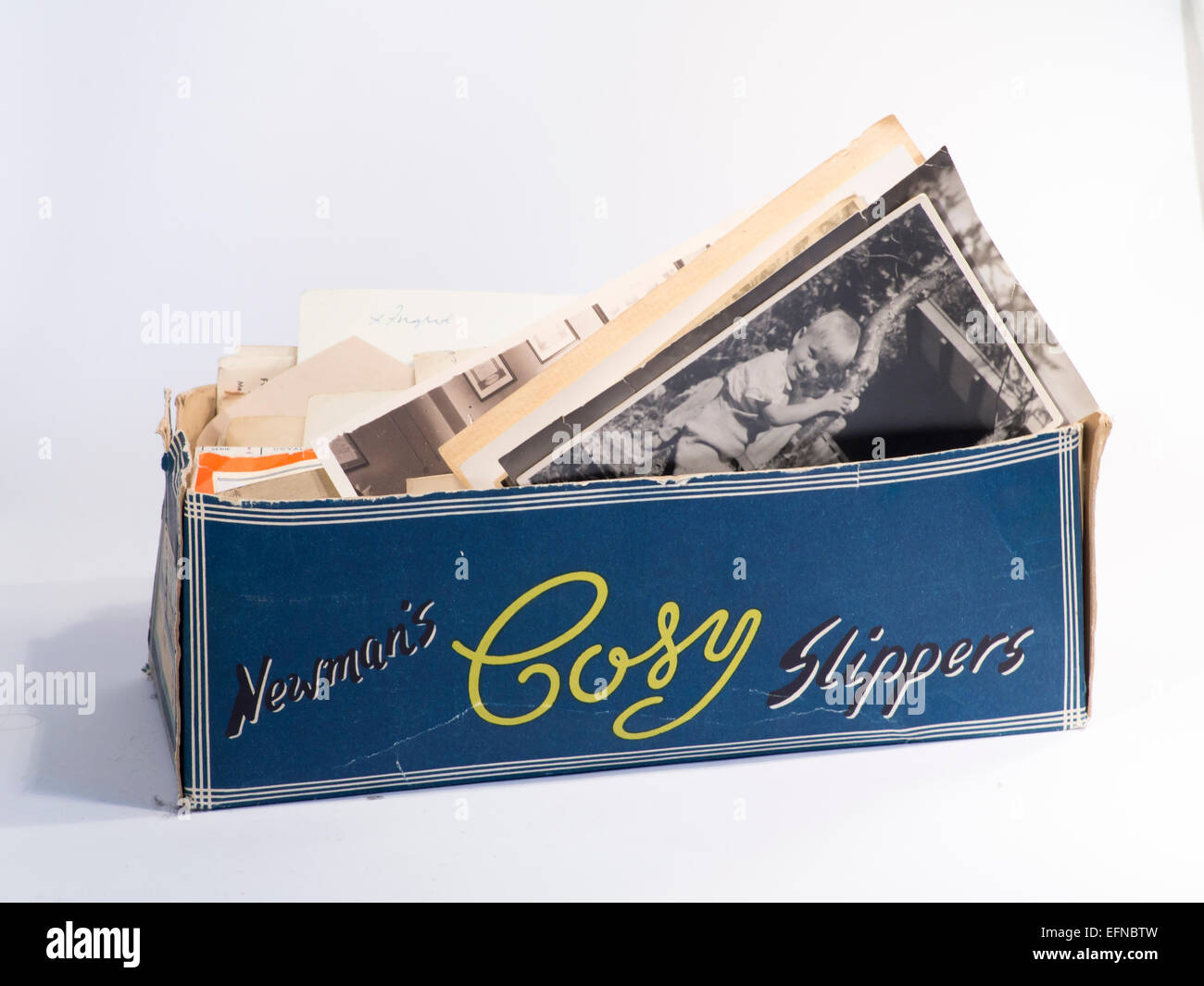 Disorganized vintage photographs and envelopes in an old English shoe ...