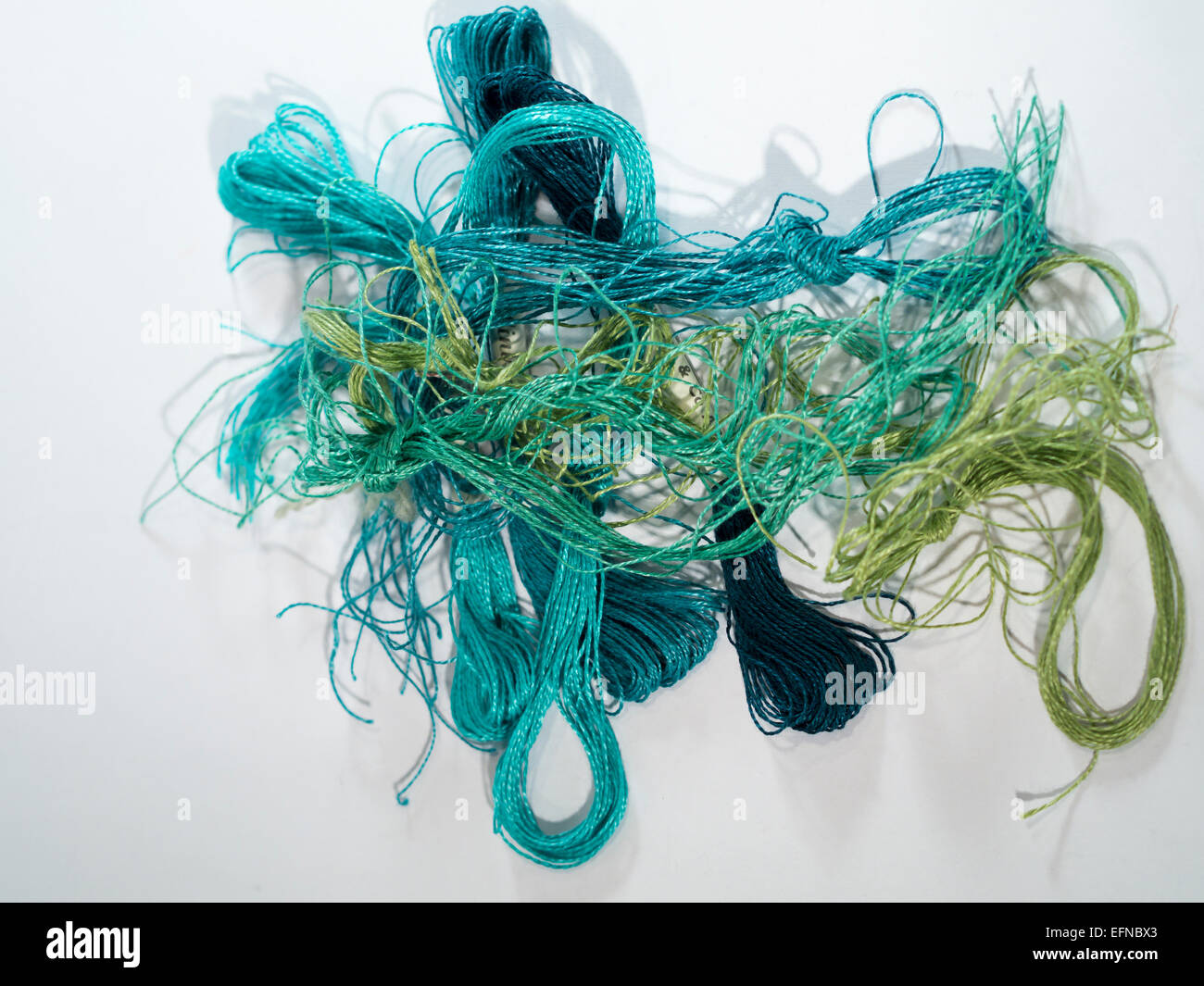 Flaxen embroidery thread in blue aqua and green shades on white ...