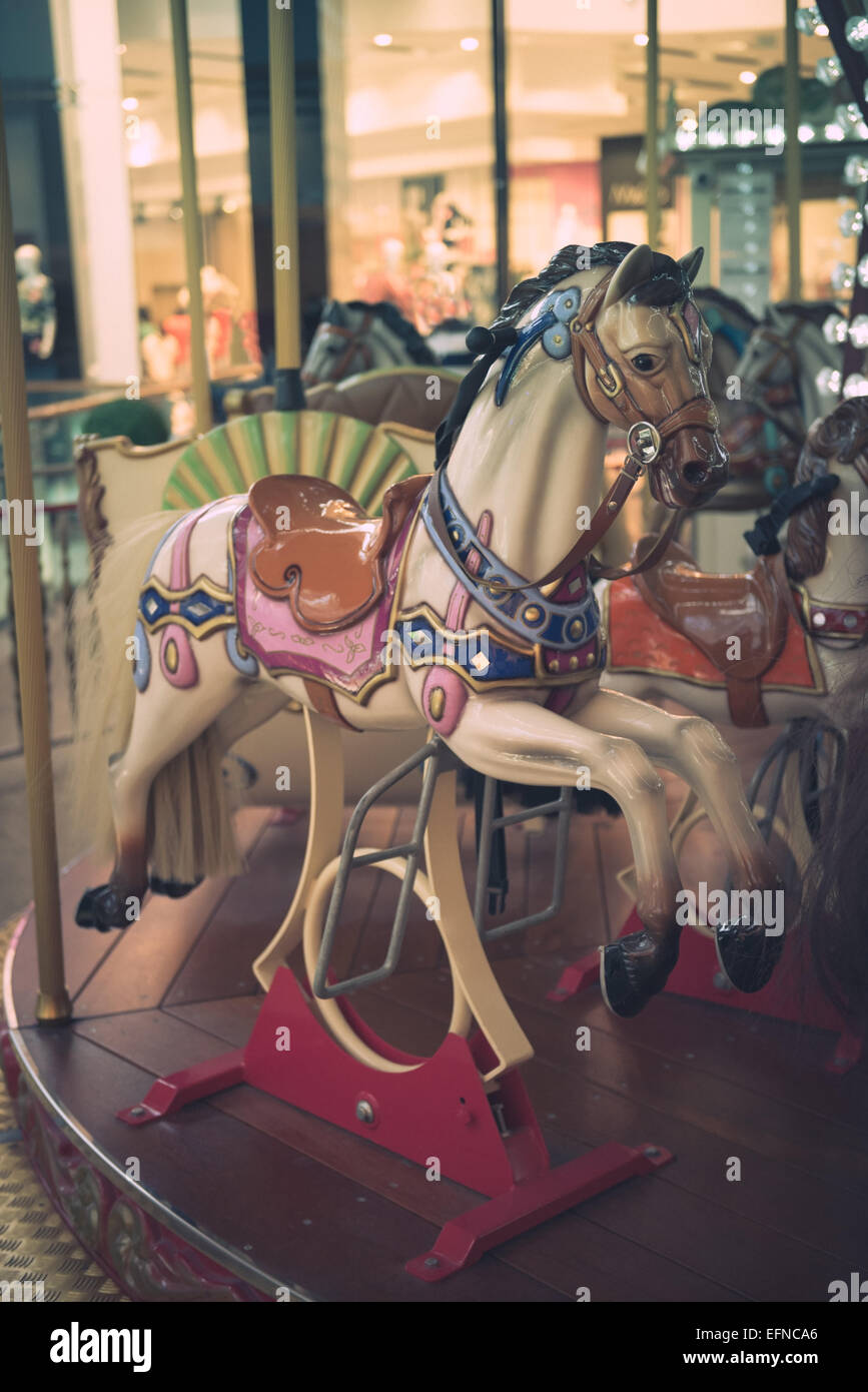 Carousel horse on a carnival merry-go-round. Vertical shot in retro ...