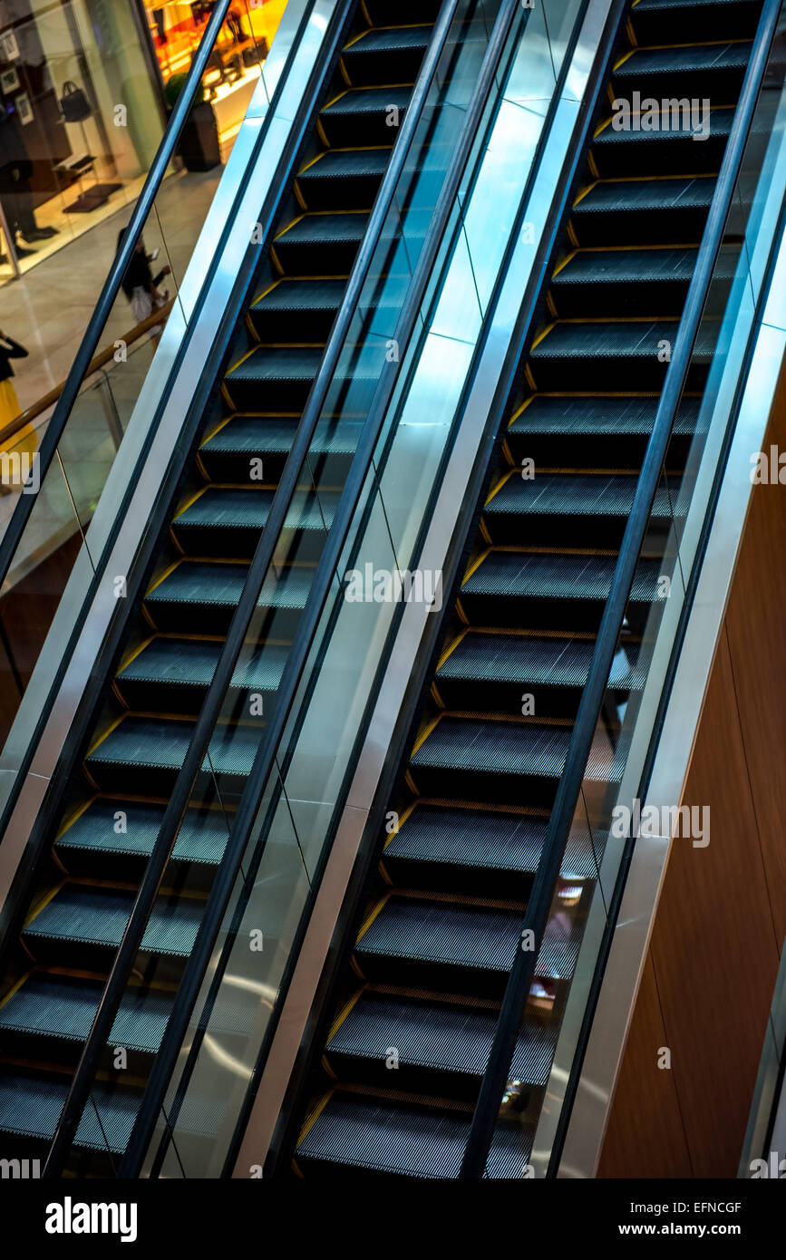 Shopping Mall Escalators. Vertical filtered shot Stock Photo - Alamy