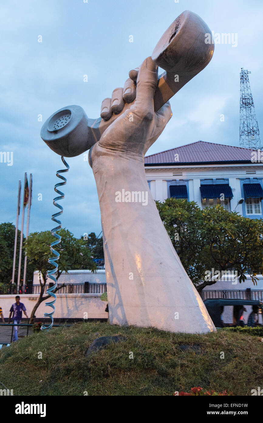 Huge statue of phone being held by a large hand outside ...