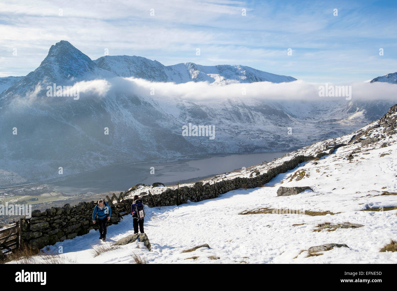 Hikers on path to Carneddau mountains above Ogwen Valley with view to ...