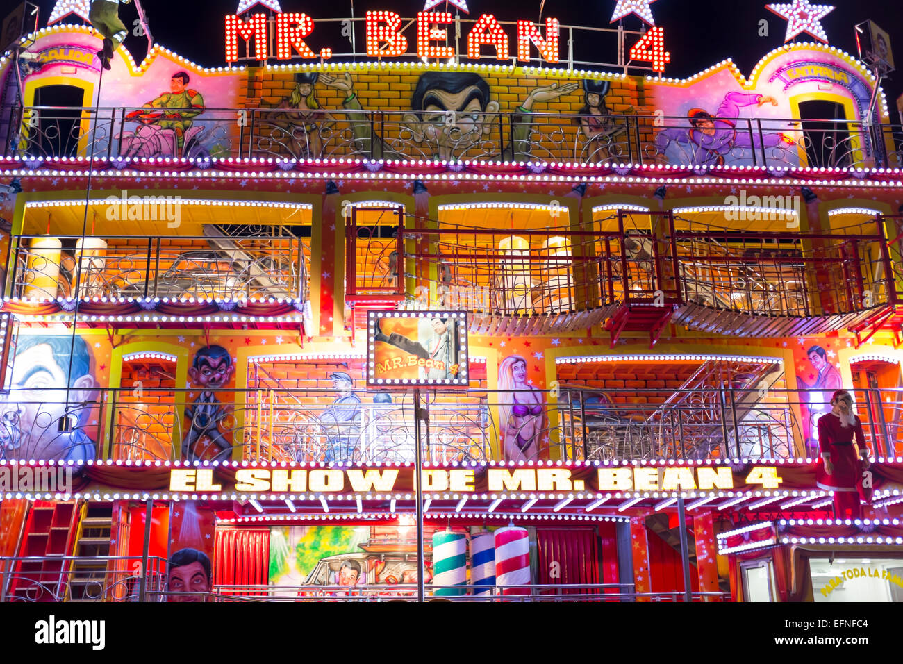 Brightly lit, illuminated neon Mr Bean 4 funhouse fairground ride at ...