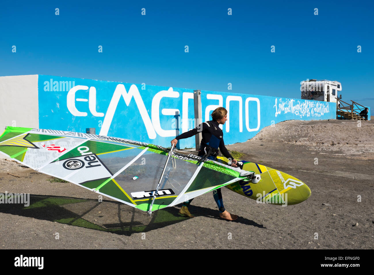Male windsurfer with rig in front of El Medano wall painting, El Médano ...