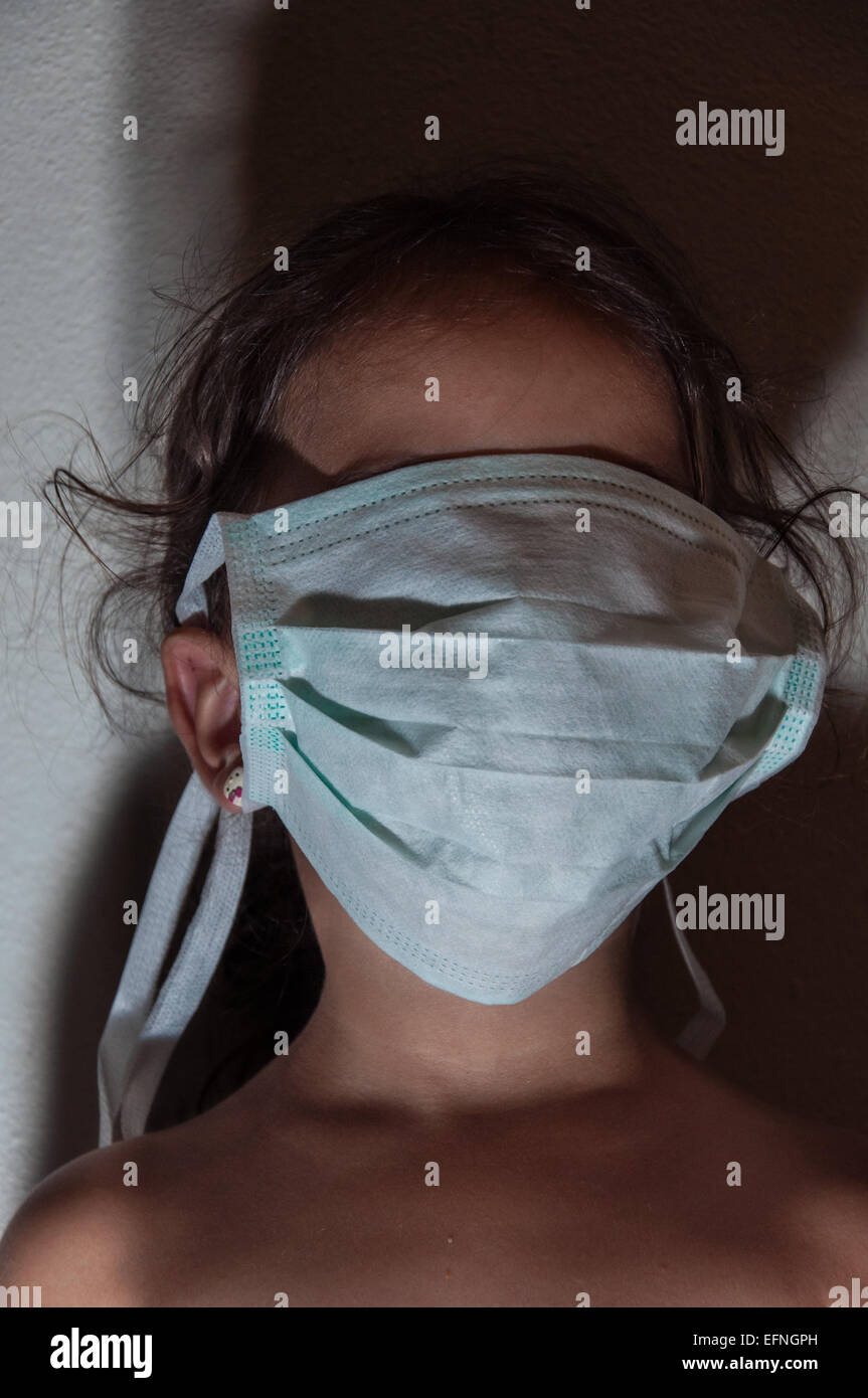 Photo of a girl with a surgical mask covering her face Stock Photo - Alamy