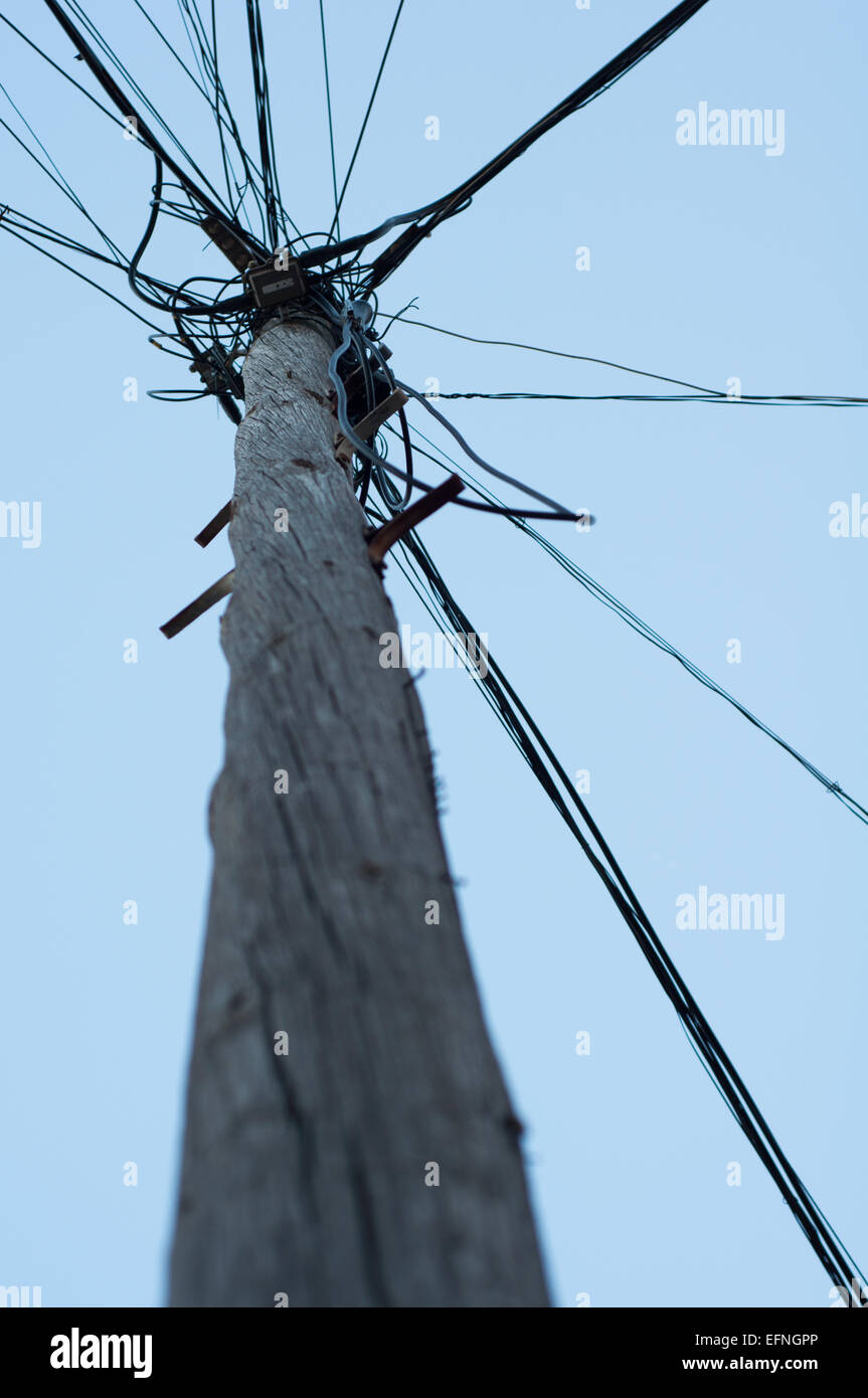 View from the bottom of a utility pole full of tangled wires Stock ...