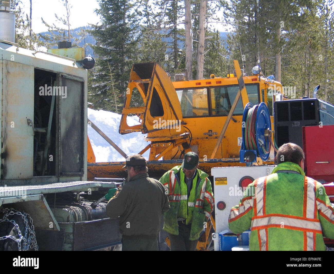 A WYDOT crew working on equipment during spring plowing in Yellowstone ...
