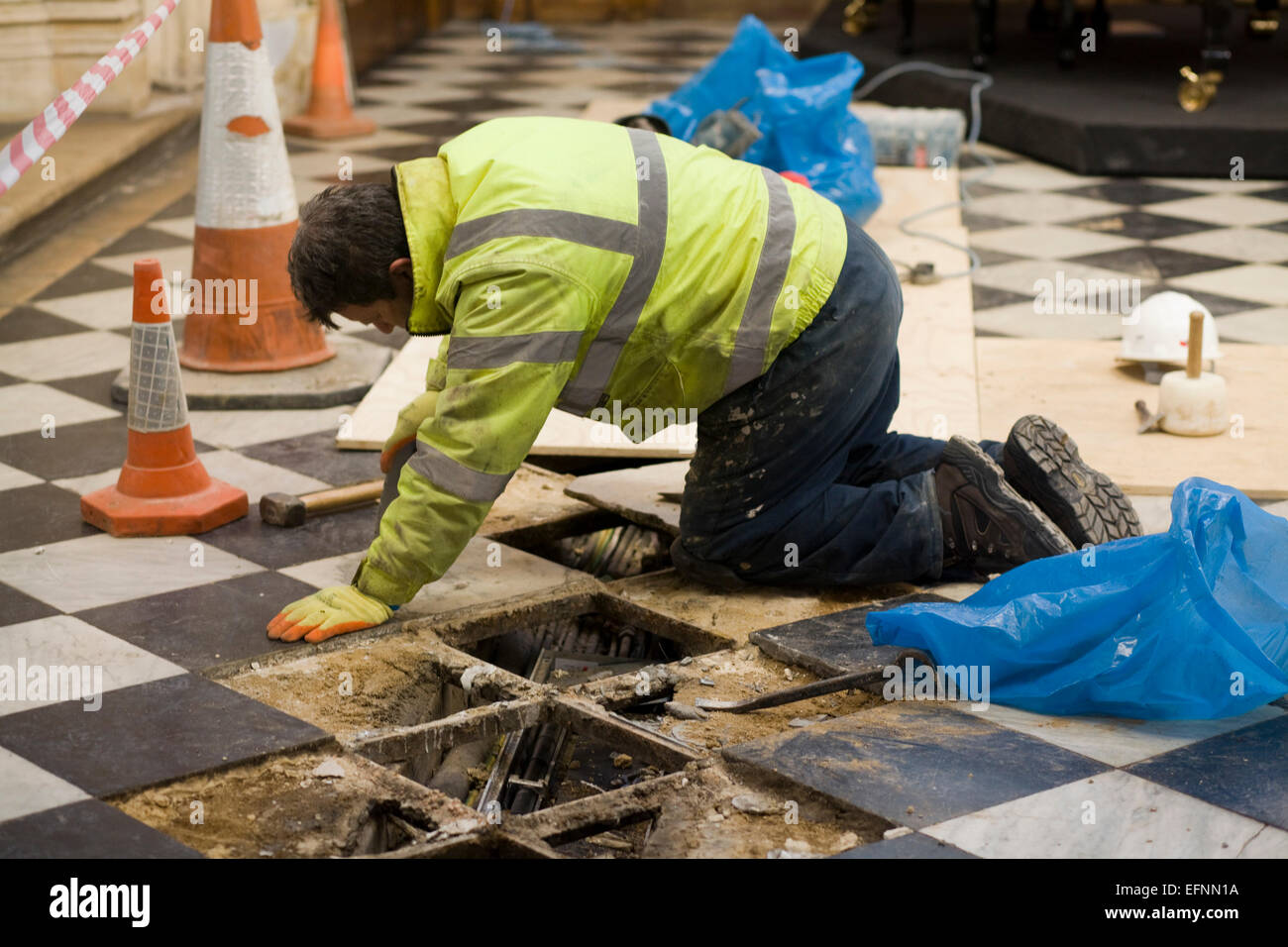 Workman working of the floor tiles in a church hi-res stock photography ...