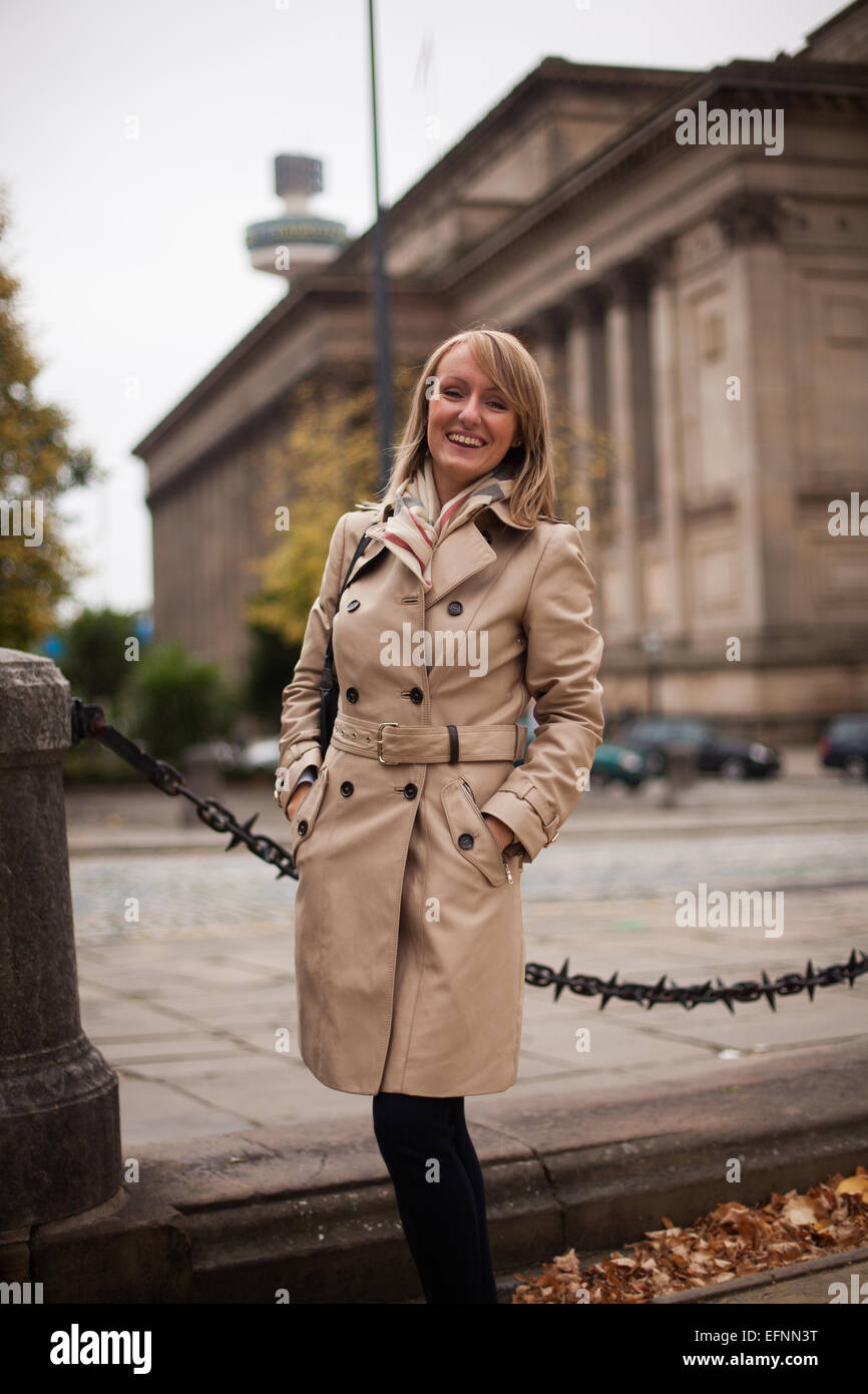 smiling woman in front of building Stock Photo - Alamy
