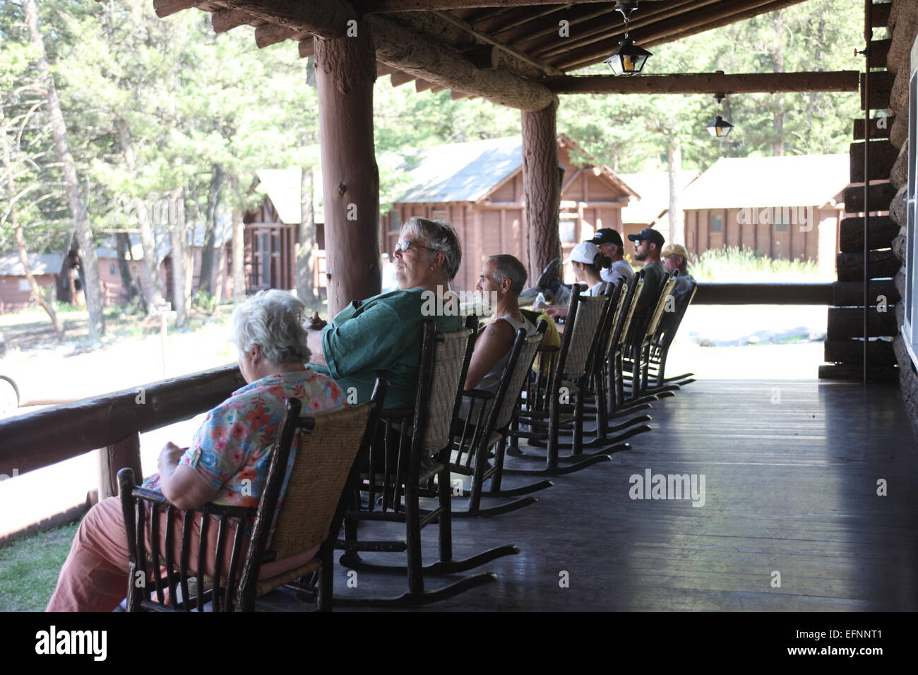 Visitors are seen sitting in rocking chairs on the porch of Roosevelt ...