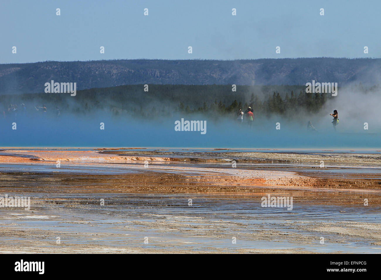 Visitors are seen walking along the boardwalk at Grand Prismatic Spring ...