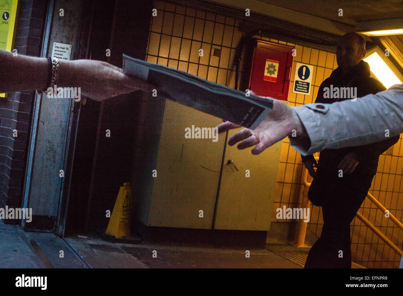 Handing the newspaper to the man Stock Photo - Alamy