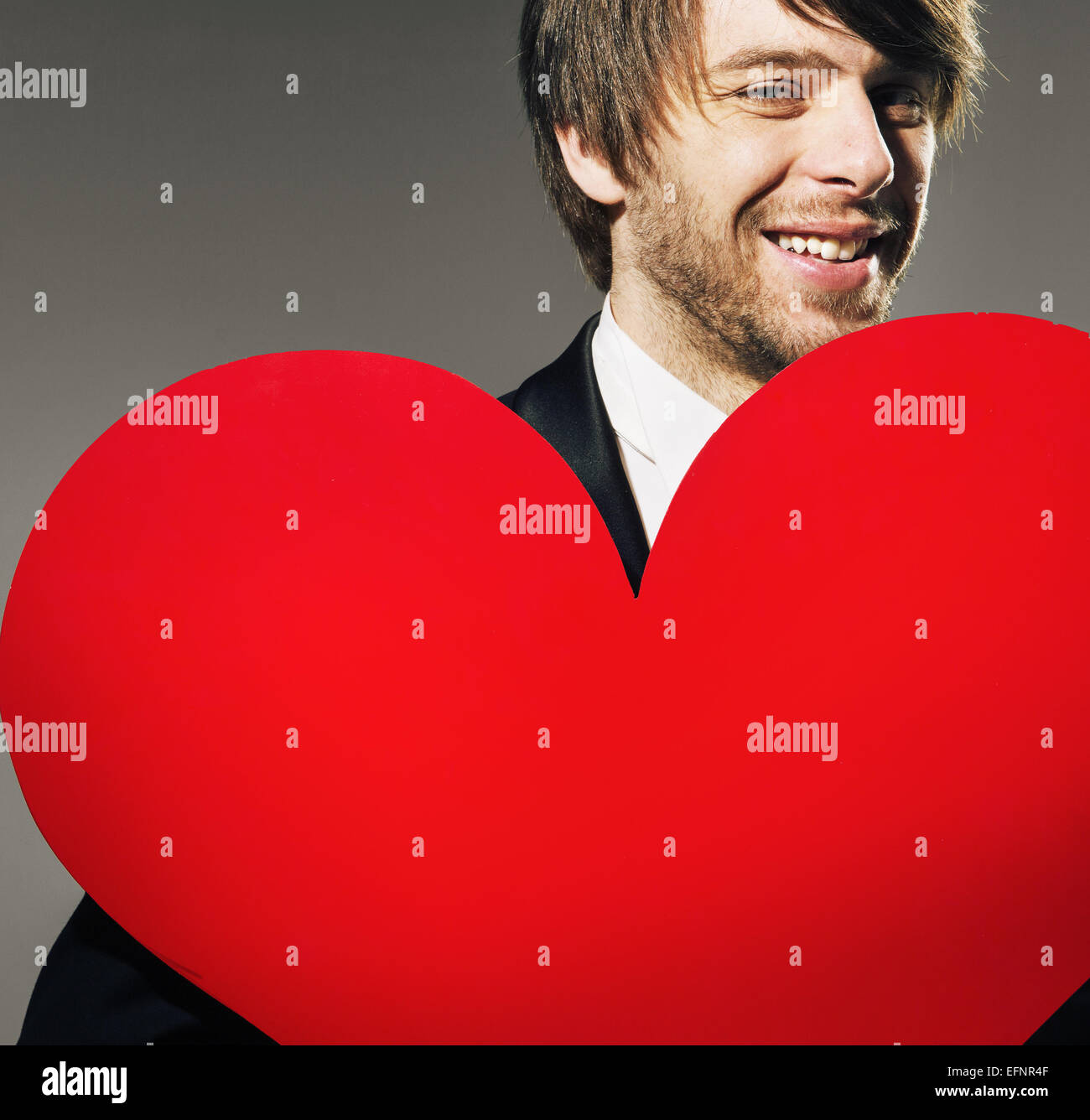 Closeup portrait of a boyfriend with a valentine's heart Stock Photo ...