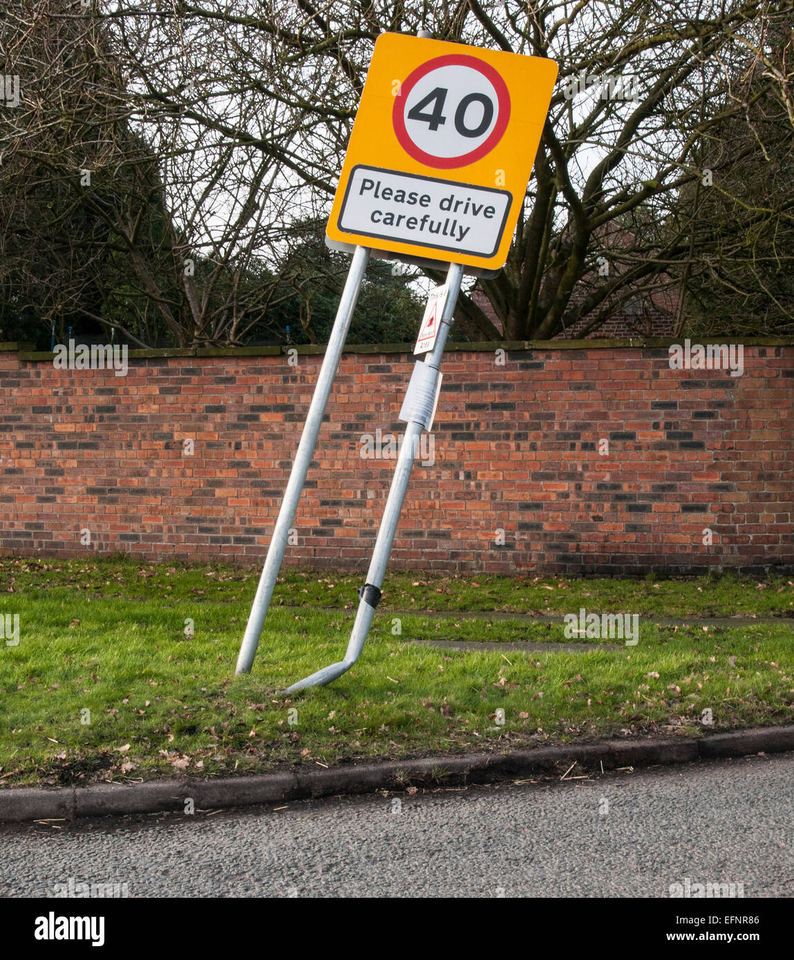 Road sign please drive carefully damaged by car Stock Photo - Alamy