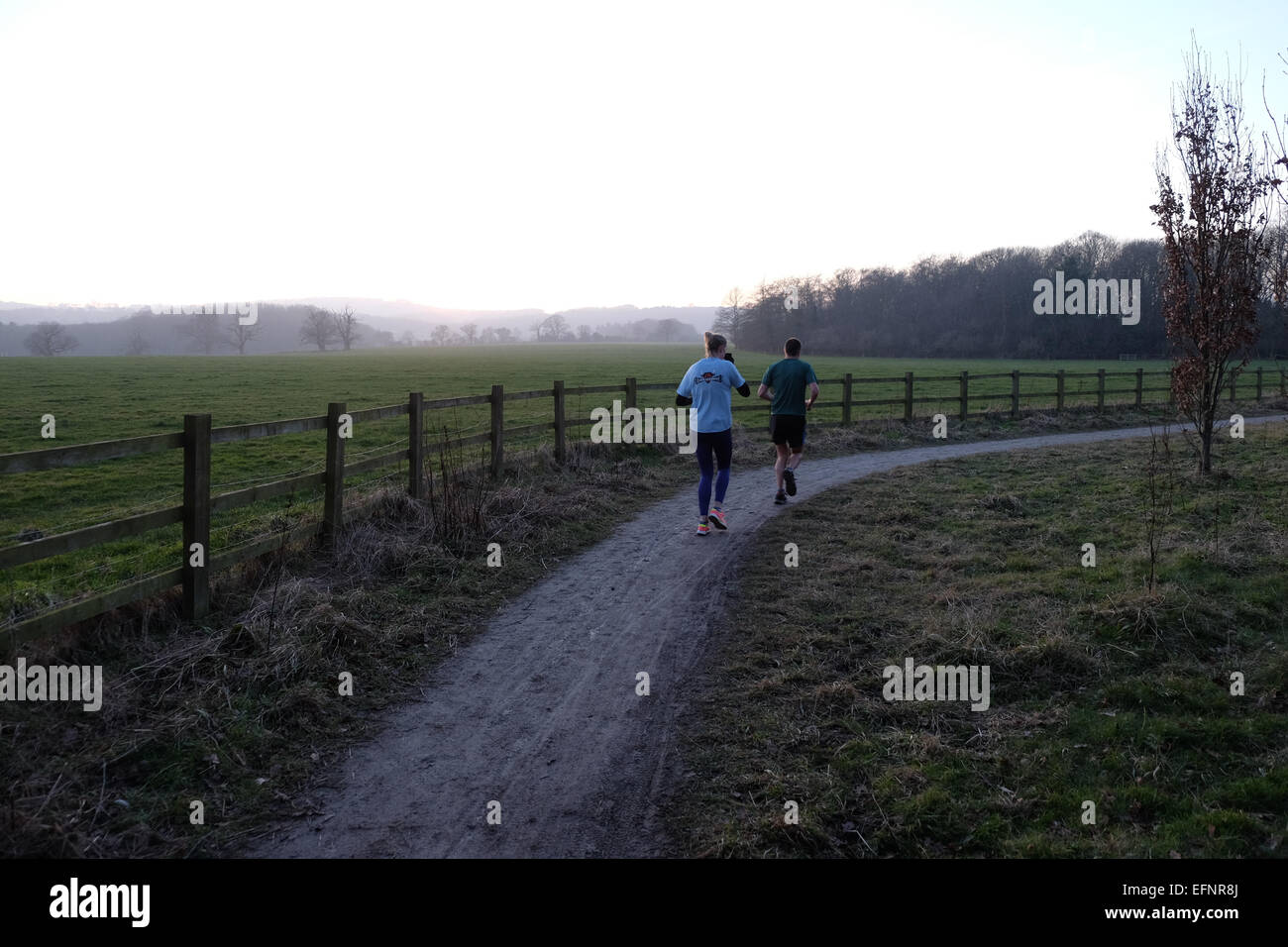 two people jogging at sunset Stock Photo - Alamy