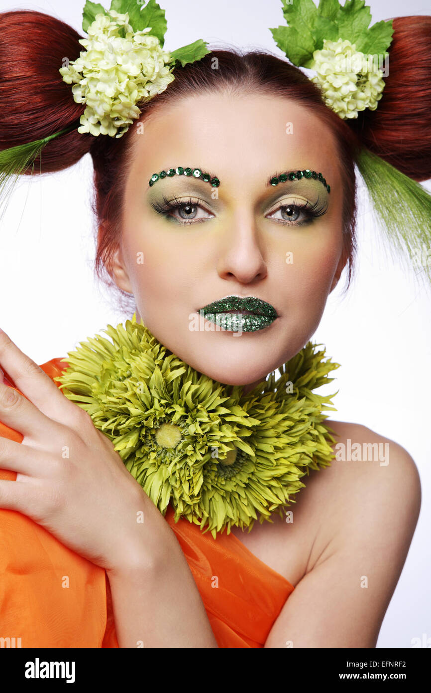 Beautiful young woman with exotic flower hair style Stock Photo - Alamy