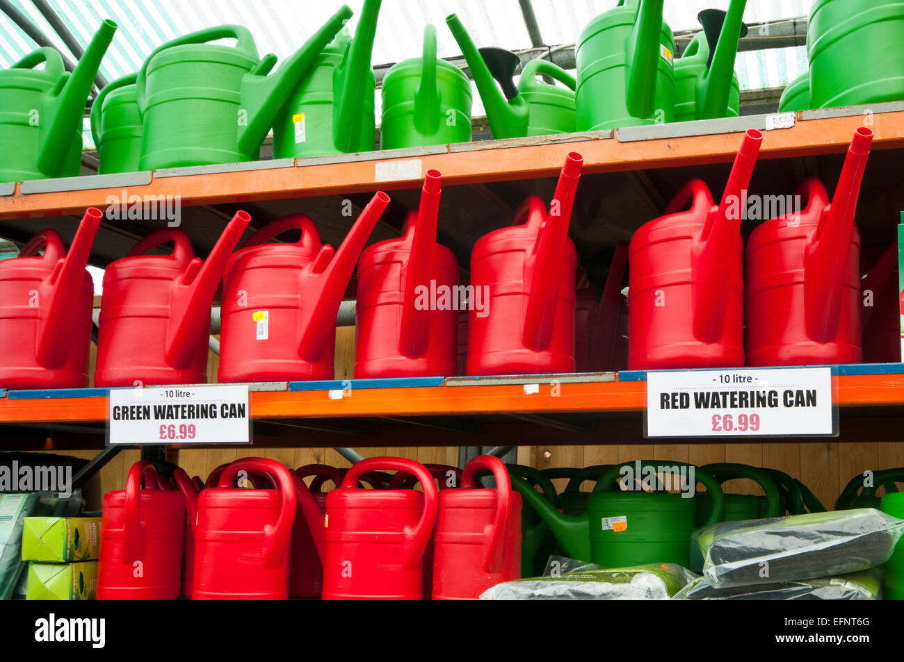 Shop Display Of Plastic Garden Watering Cans Stock Photo - Alamy