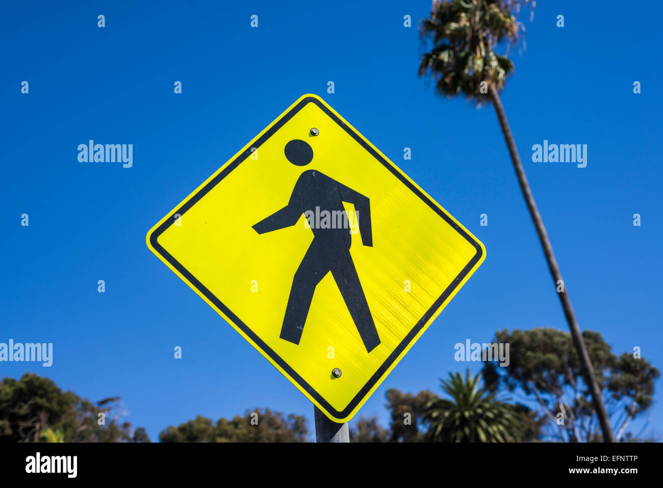 People walking warning sign. Yellow and black sign Stock Photo - Alamy