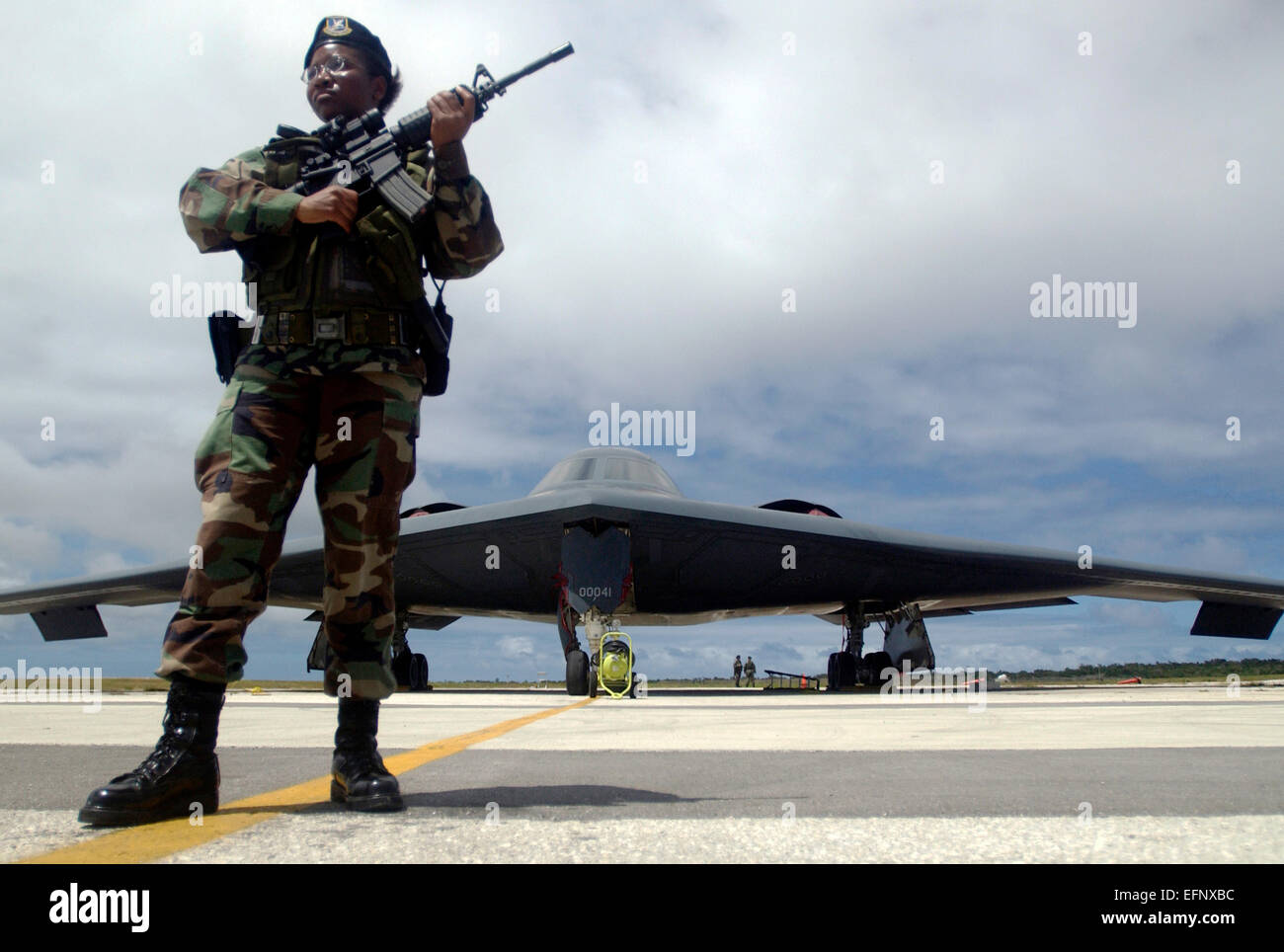US Air Force Airman Keundra McFadden guards a B-2 Spirit stealth bomber ...