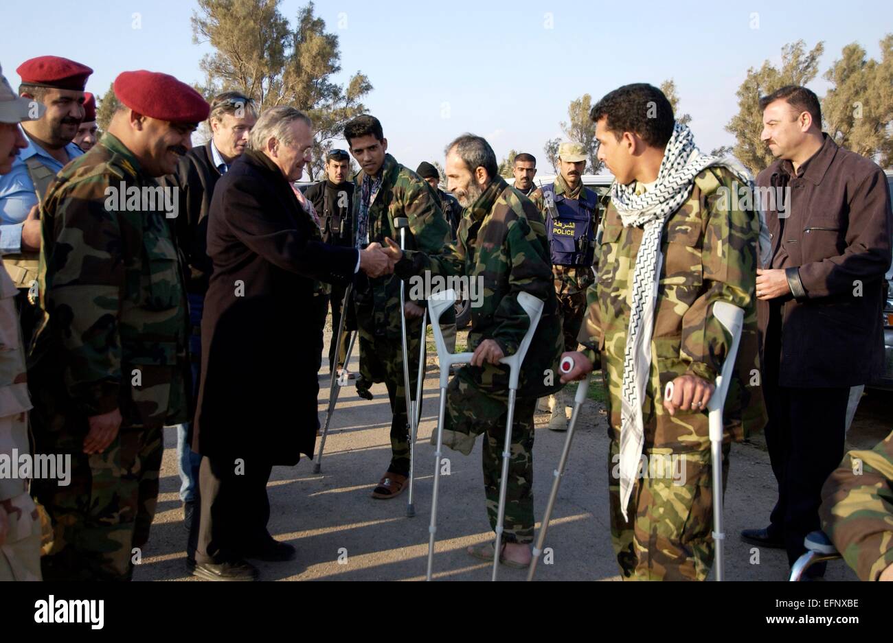 US Secretary of Defense Donald Rumsfeld shakes hands with members of ...