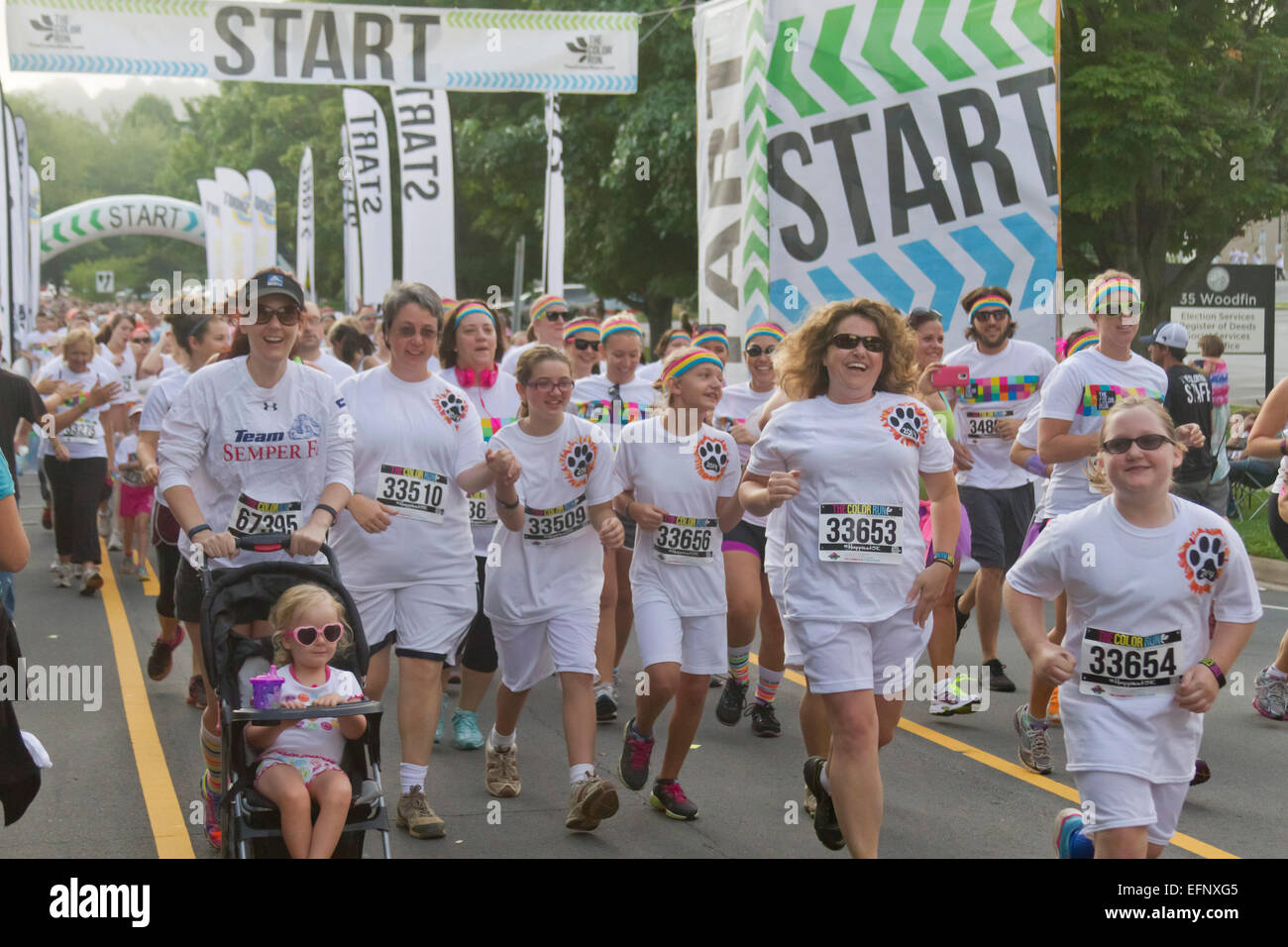 Happy Color Run crowd takes off from the starting line on July 26, 2014 ...