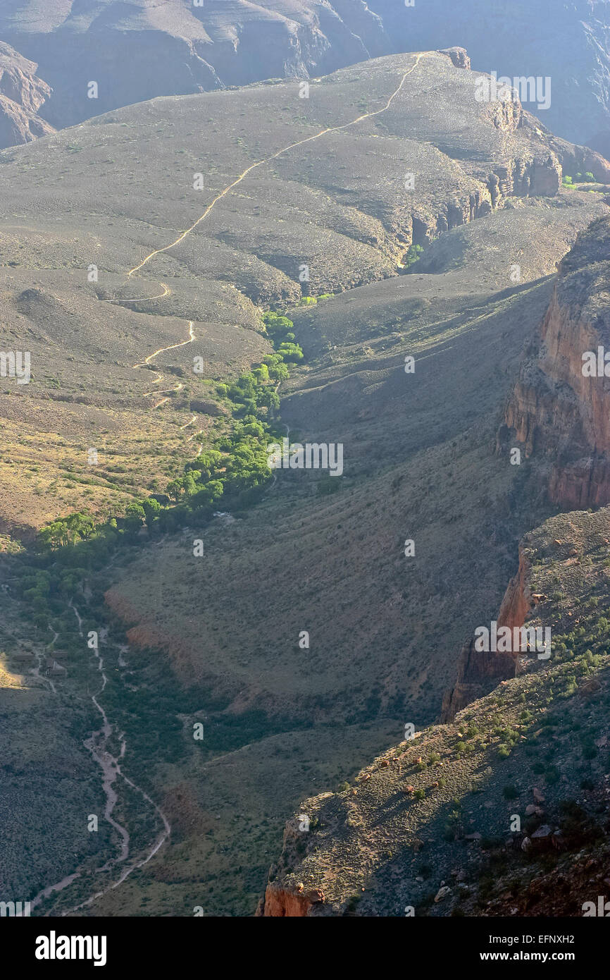 A distant river oasis below running through the arid desert and ...