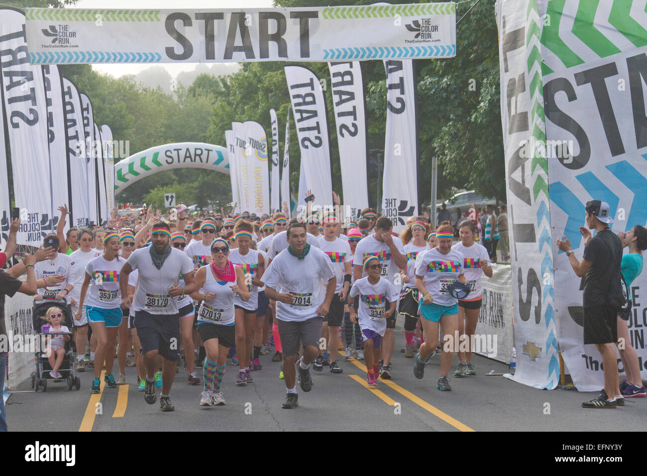 Color Run Runners of all ages and genders wearing colorful t-shirts and ...