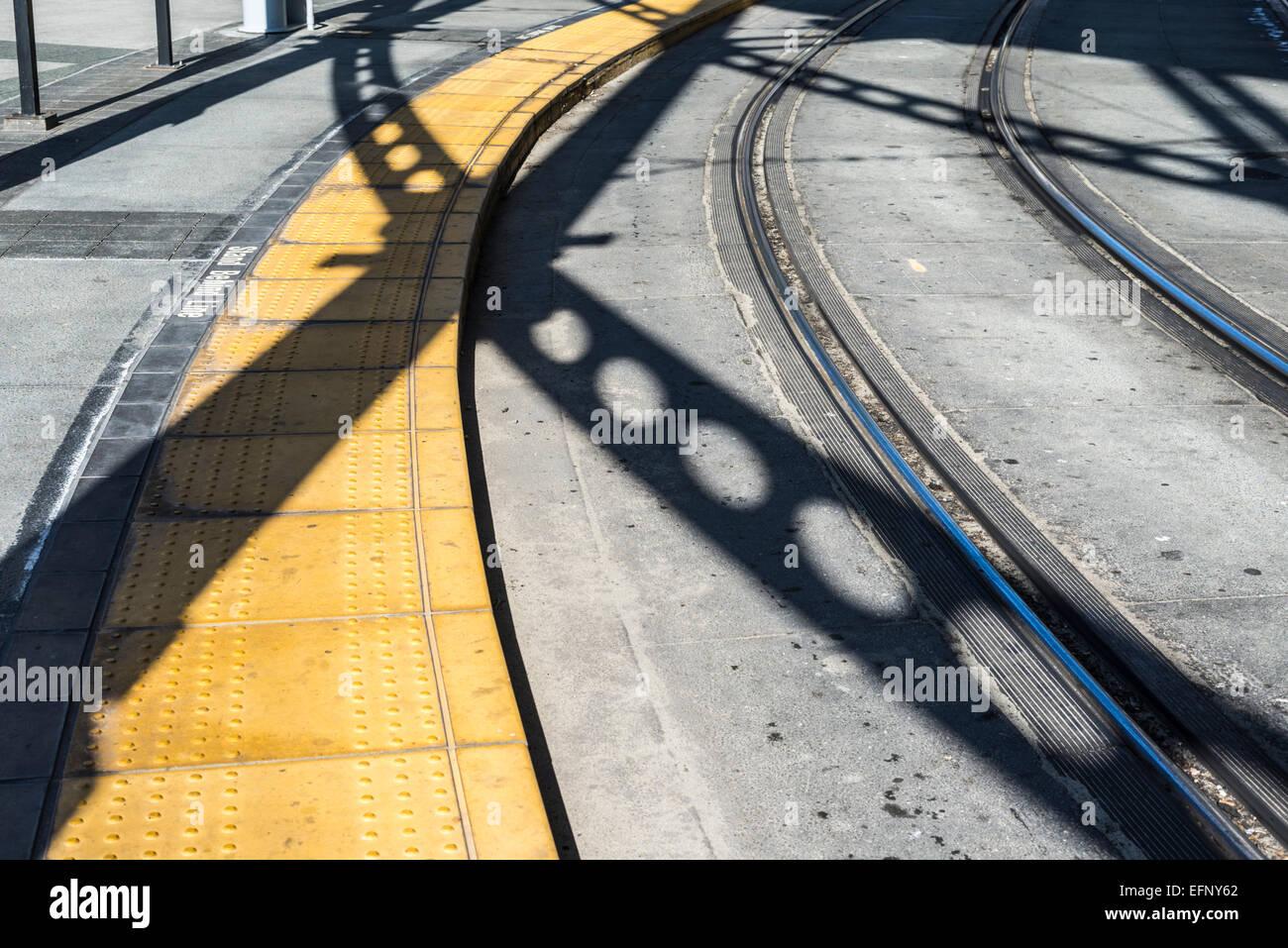Shadows and patterns across train tracks Stock Photo - Alamy
