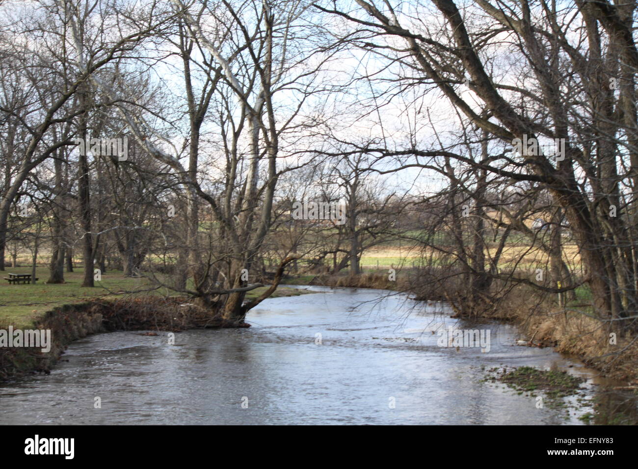 Fast moving, flooded creek due to recent rain and snow Stock Photo - Alamy