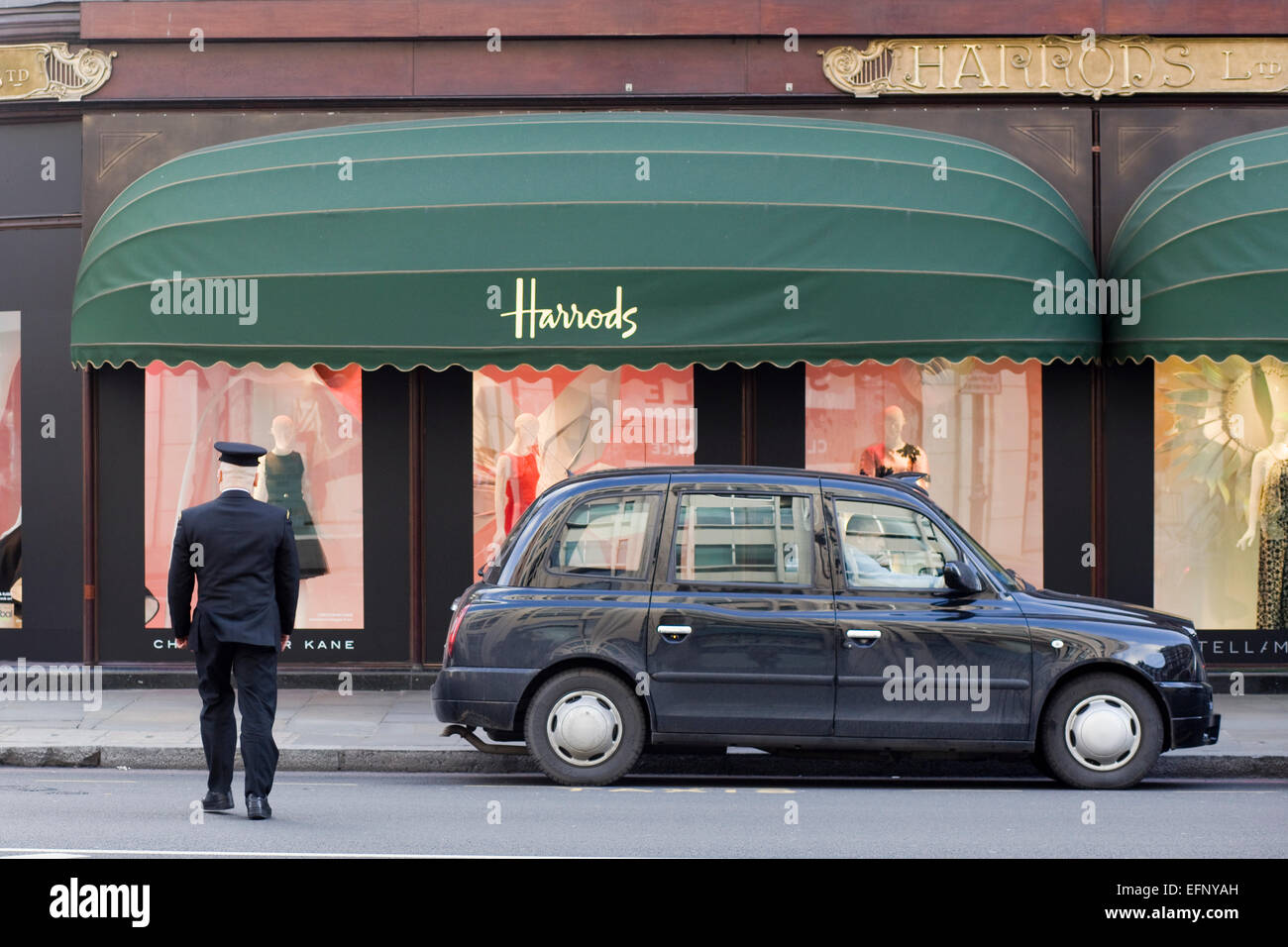 The Harrods building frontage with chauffeur and taxi cab outside Stock ...