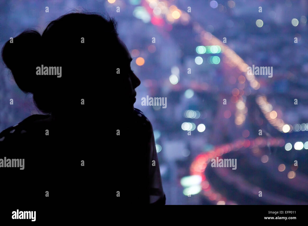 Young woman watching the view from skyscraper Stock Photo - Alamy