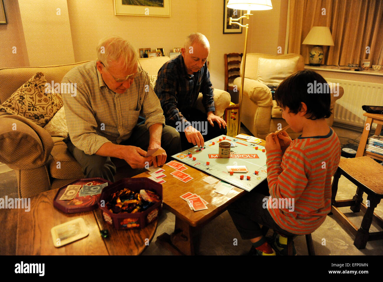 Family playing Monopoly at Christmas in North Yorkshire, Uk Stock Photo ...