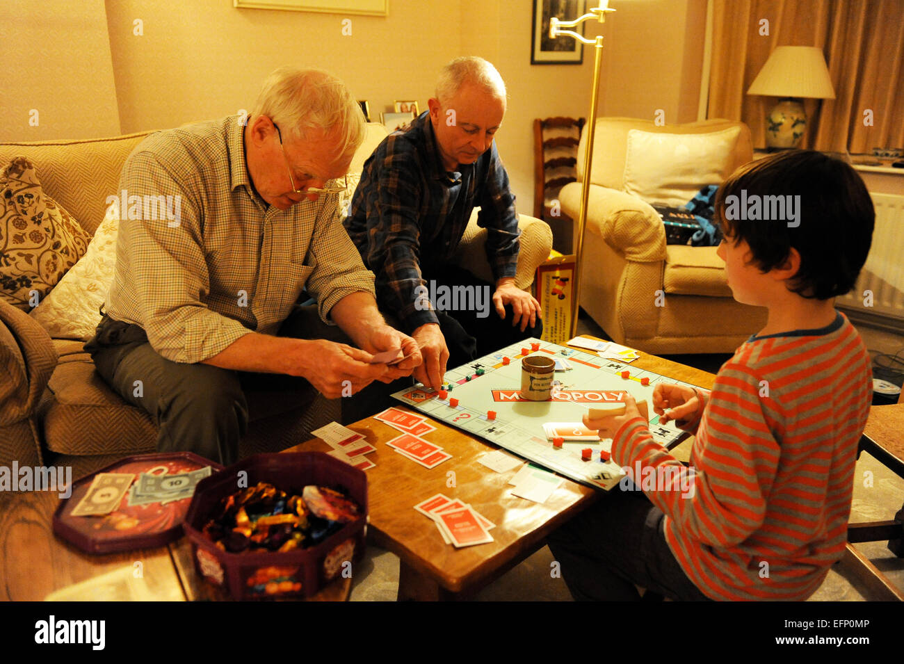Family playing Monopoly at Christmas in North Yorkshire, Uk Stock Photo ...
