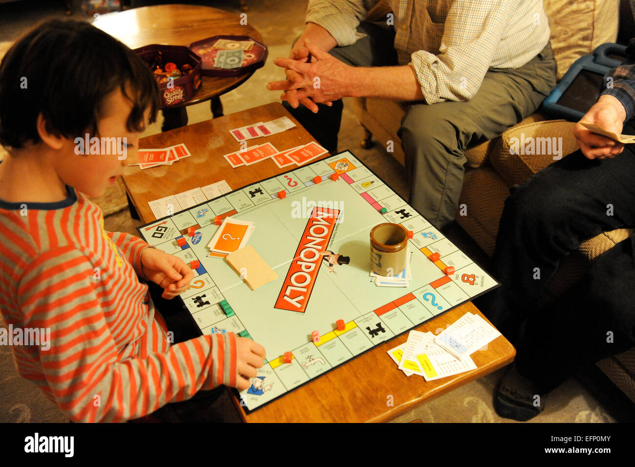 Family playing Monopoly at Christmas in North Yorkshire, Uk Stock Photo ...