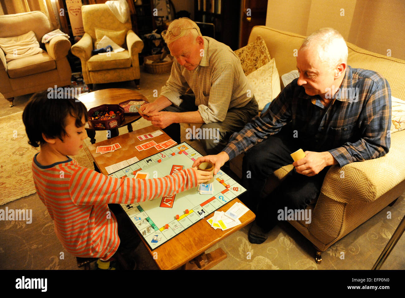 Family playing Monopoly at Christmas in North Yorkshire, Uk Stock Photo ...
