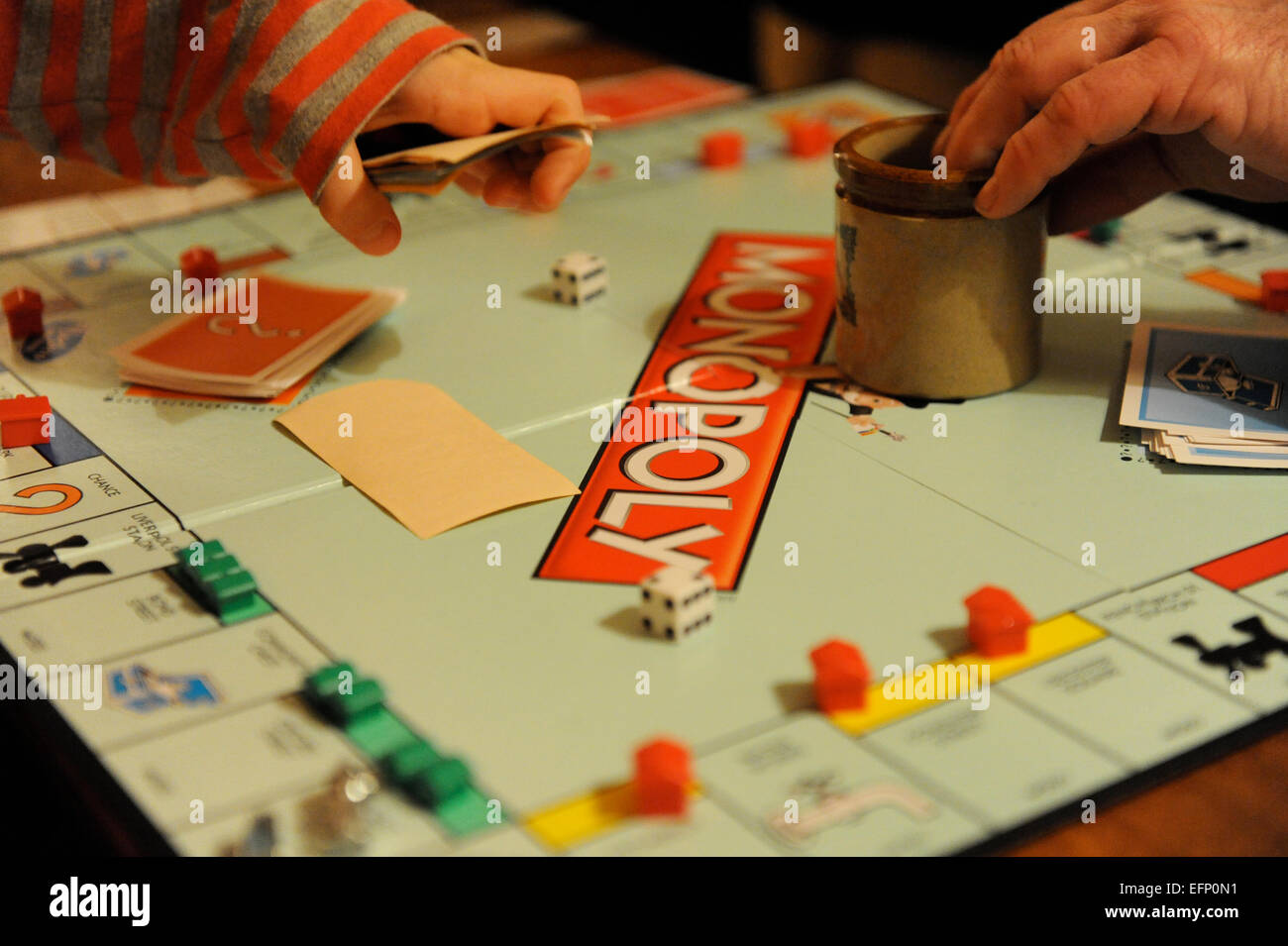 Family playing Monopoly at Christmas in North Yorkshire, Uk Stock Photo ...