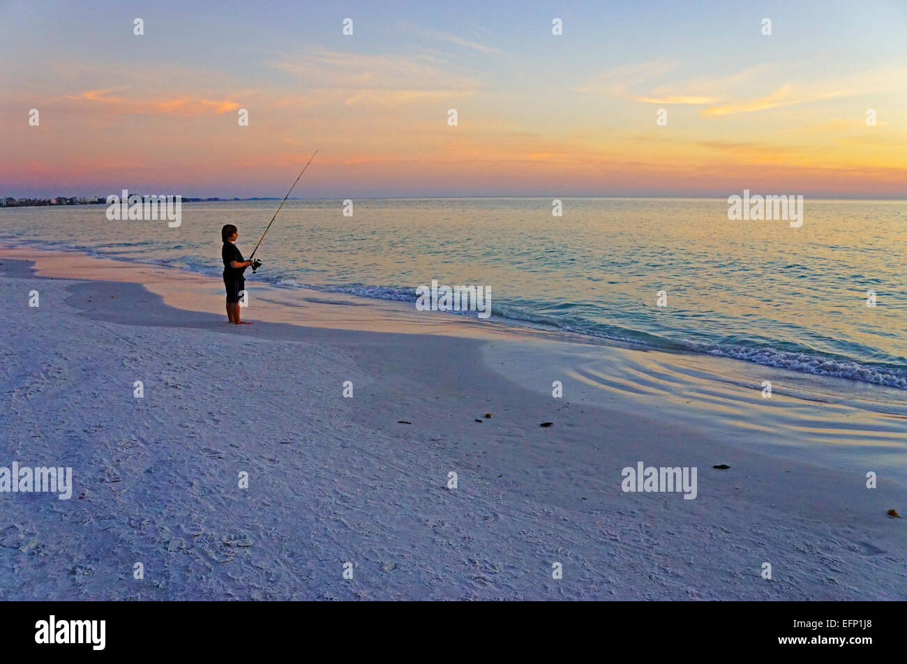 Boy fishing at sunset on Siesta Key Beach at Sarasota, Florida Stock ...