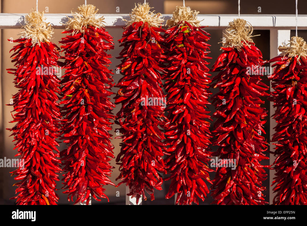 Red, ristra hanging chili peppers as a background Stock Photo - Alamy