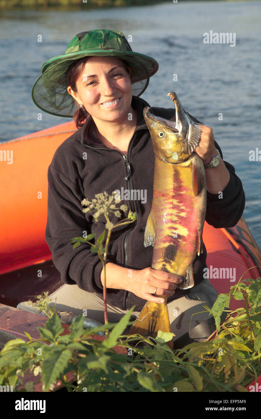 Woman with salmon fish in her hands, Kamchatka Peninsula, Russia Stock ...