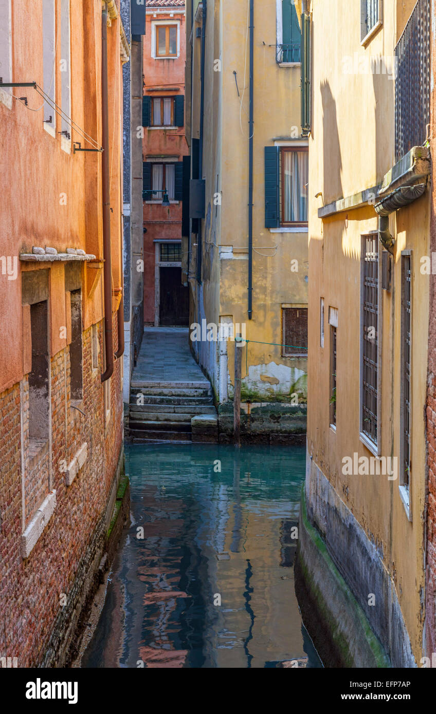 Image of a specific small and narrow canal between buildings in Venice ...