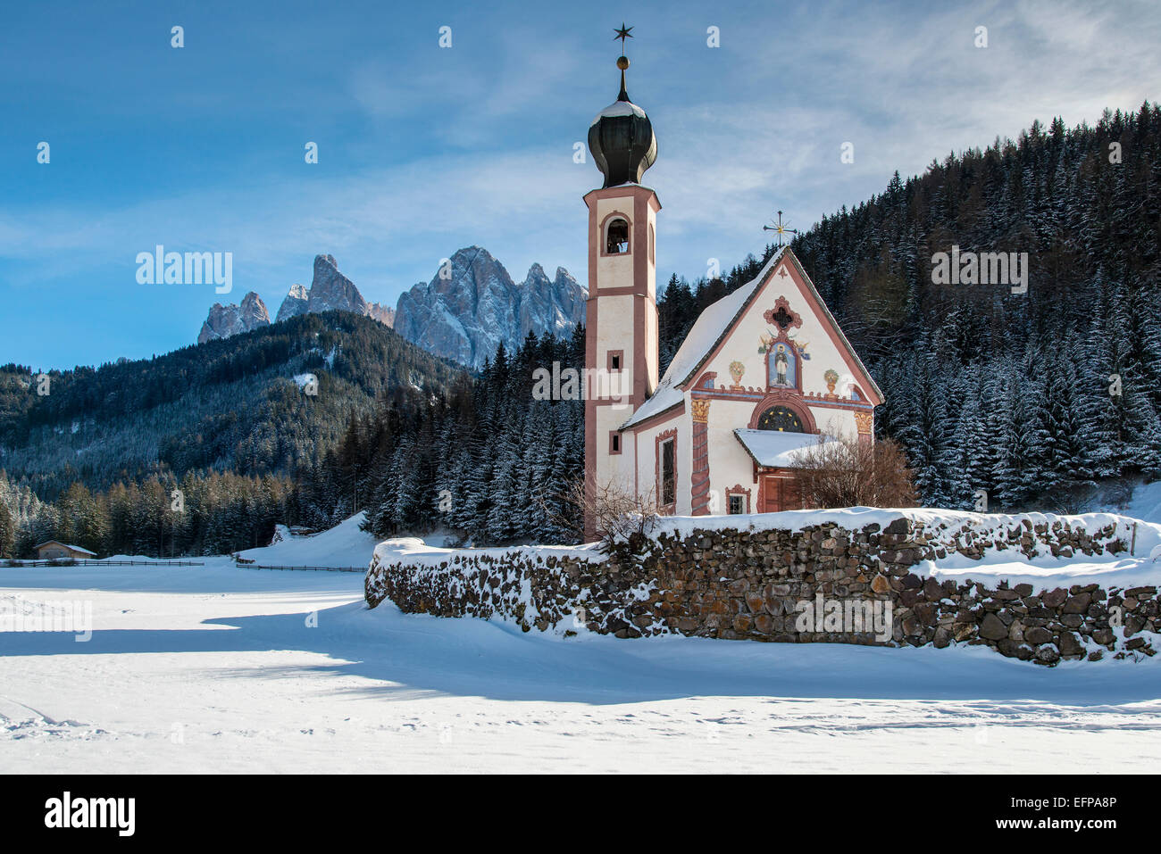 Winter view of St Johann in Ranui church with Puez-Geisler Dolomites ...